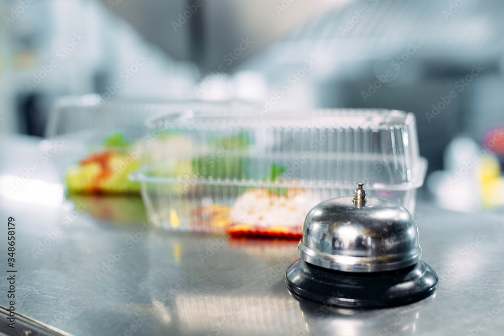 food delivery. distribution table in a restaurant with a metal bell ...