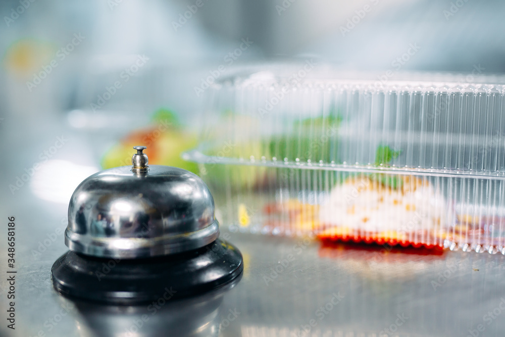 food delivery. distribution table in a restaurant with a metal bell ...