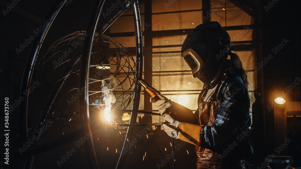 Beautiful Female Artist is Welding a Brutal Metal Sculpture in a Dark ...
