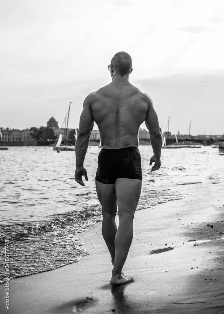 Muscled male model at the beach with a view to Saint-Petersburg Stock ...
