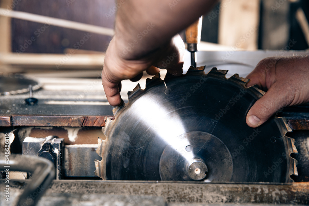 replacement of a gear wheel on a circular saw in a joinery Stock Photo ...