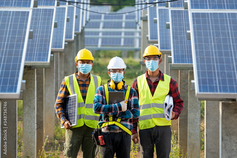 Technician and Engineer working in Solar cell Farm through field of ...