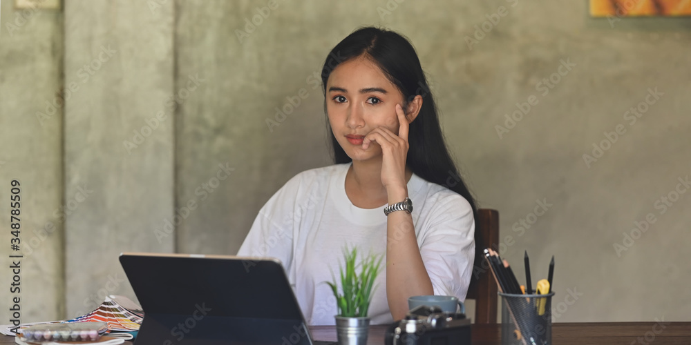 Photo of creative woman writing on computer tablet with keyboard case ...