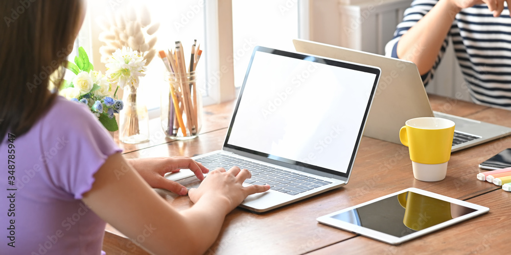Cropped of university students tutoring/doing their homework together ...