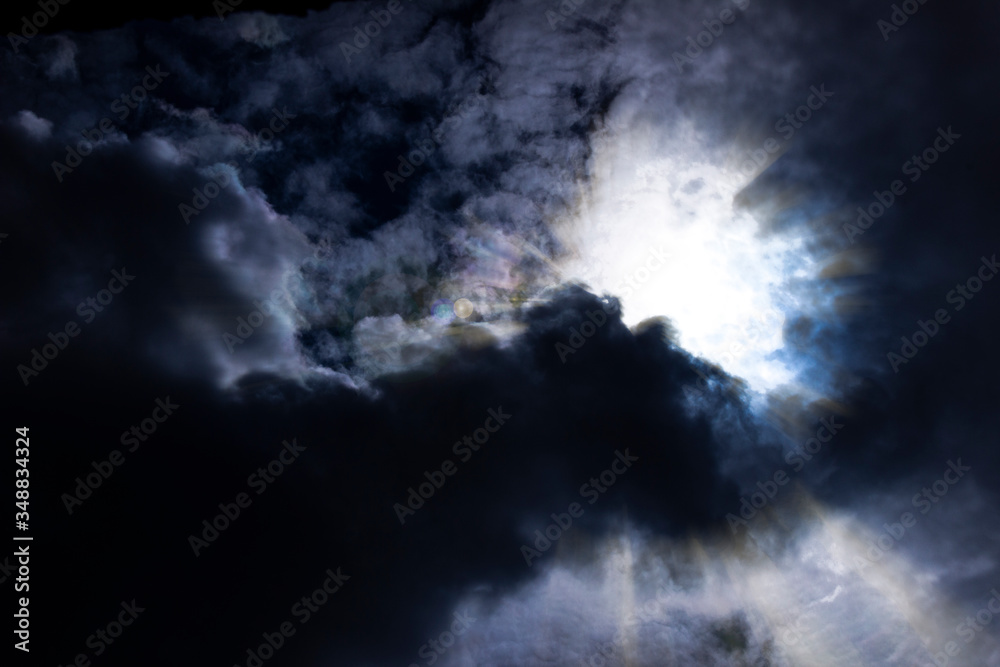 Sun rays breaking through thunderclouds, light coming out of the ...