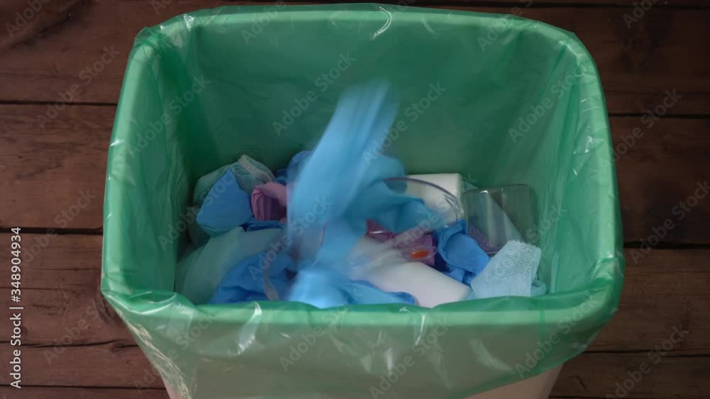 End Covid-19 pandemic. Used face masks and gloves throwaway in trash ...