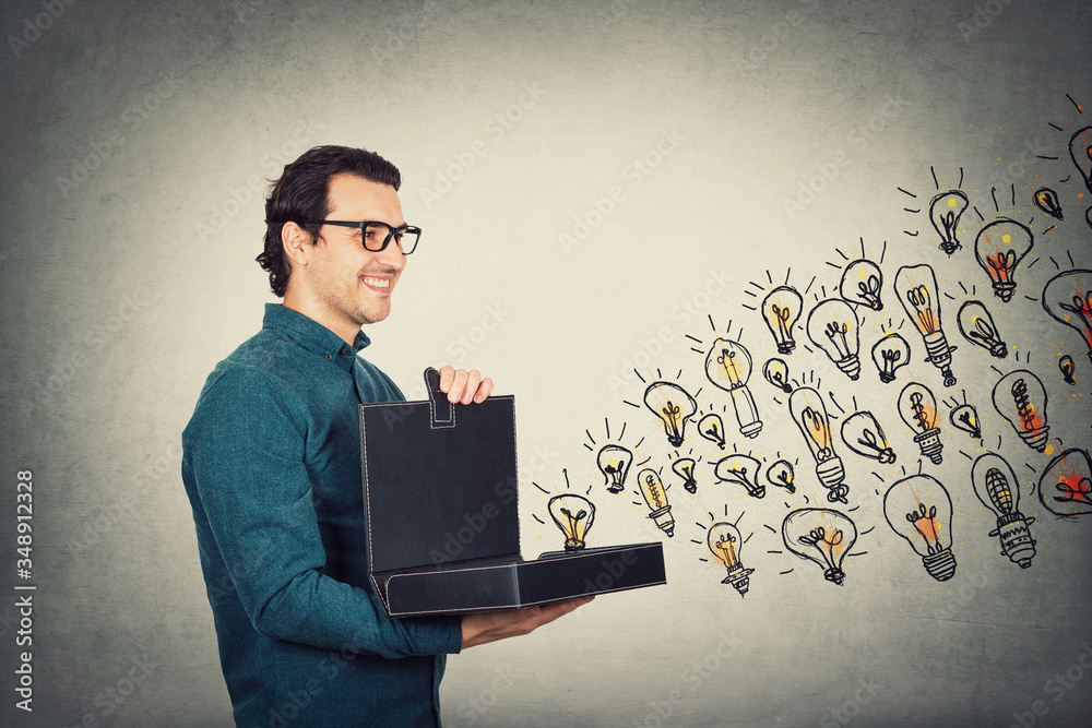 Businessman opens his briefcase filled with brilliant ideas as ...
