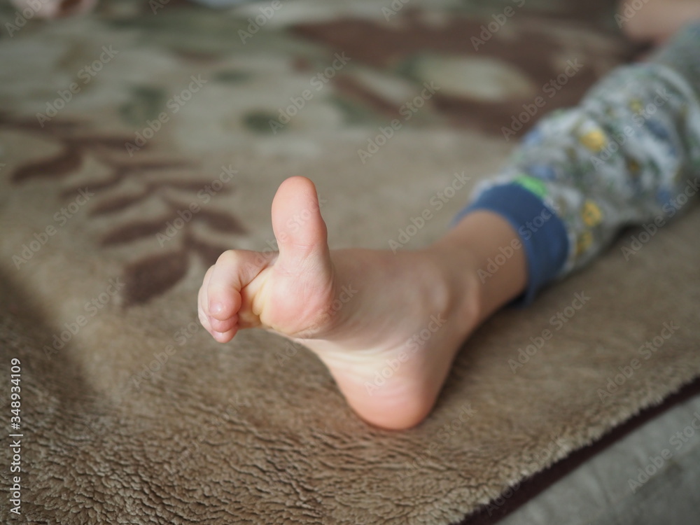 child foot shows symbol like lying on the couch at home Stock Photo ...