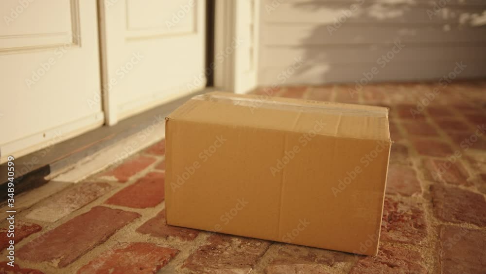 Contactless delivery of a parcel, courier delivering package to the ...