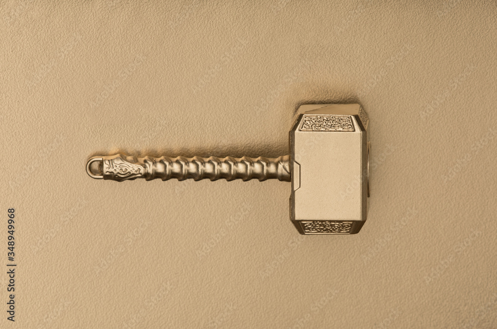 golden war hammer isolated on a gold background Stock Photo | Adobe Stock