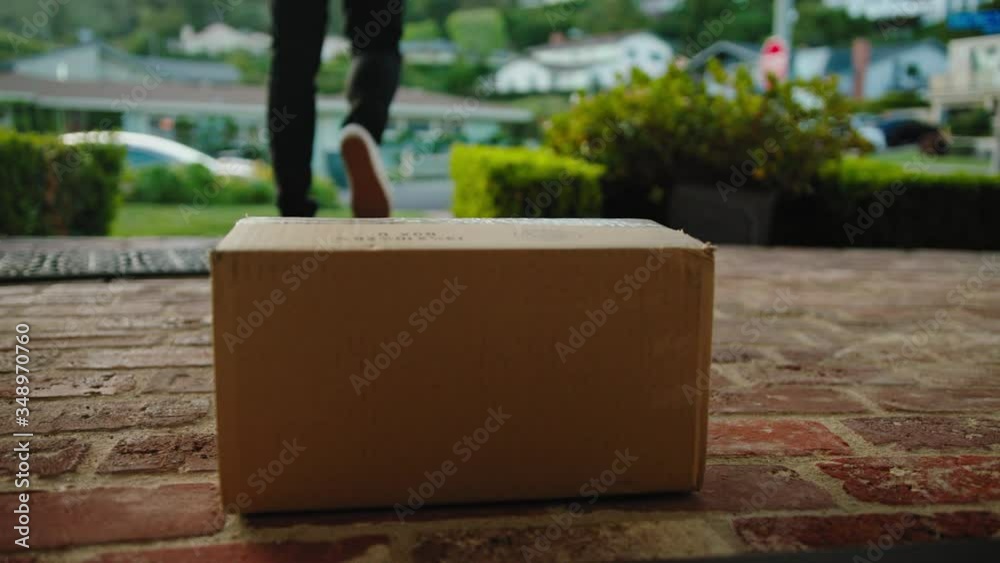Contactless delivery of a parcel, courier delivering package to the ...