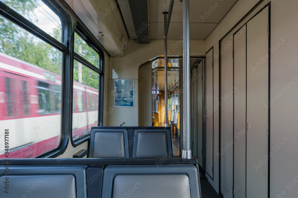 Interior view of a corridor inside passenger trains with old grey seats ...