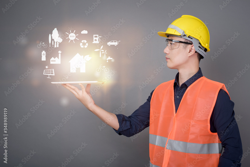 Engineer man is holding digital engineering plan with ecological data ...