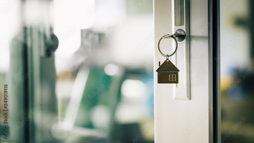 House model and key in house door. Real estate agent offer house ...