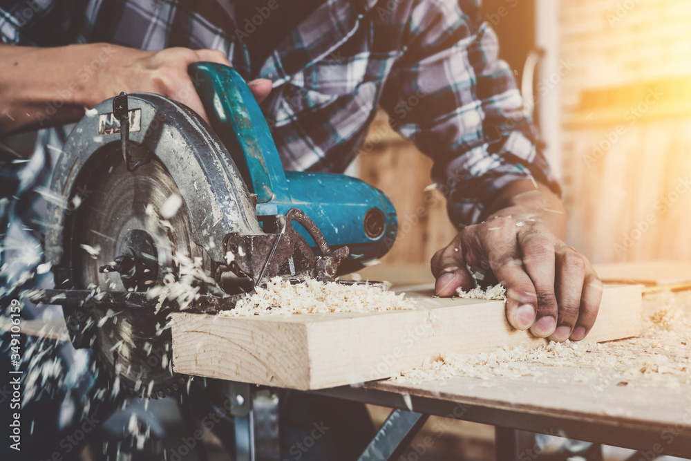 Carpenter working on wood craft at workshop to produce construction ...