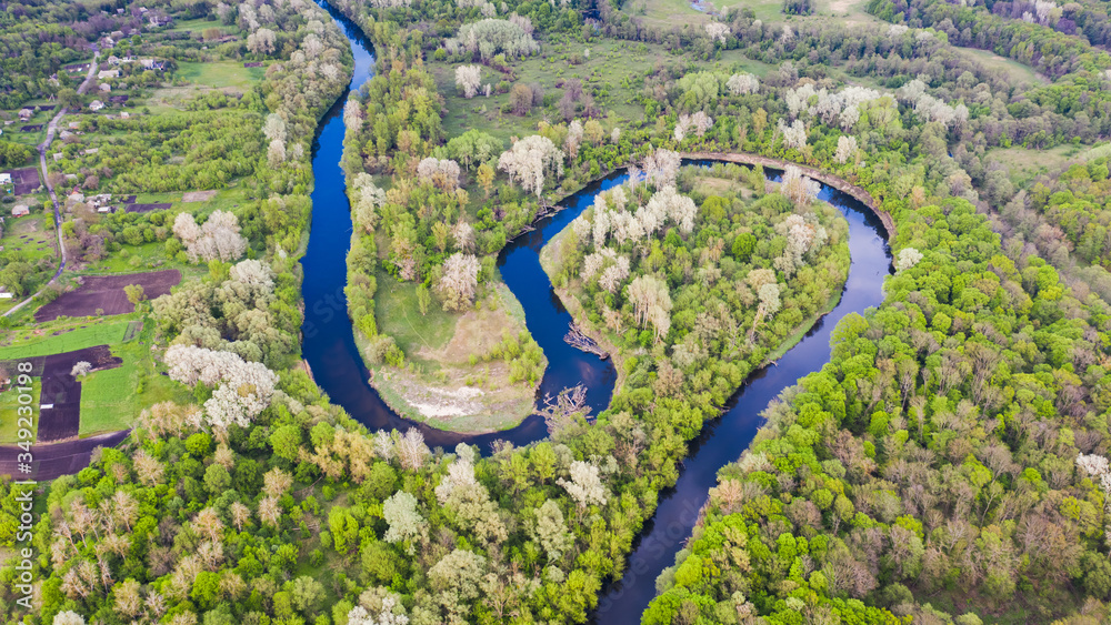 Aerial top down view of Ukrainian plain river Psel during spring time ...