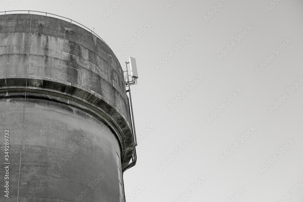 Detailed view of a large cast-concrete water tower, showing its ...