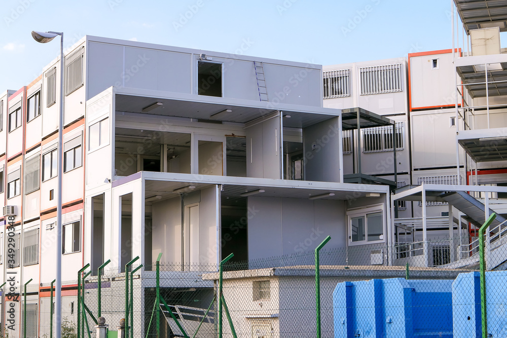 Prefabricated modular offices. Stacking of boxes for construction site ...
