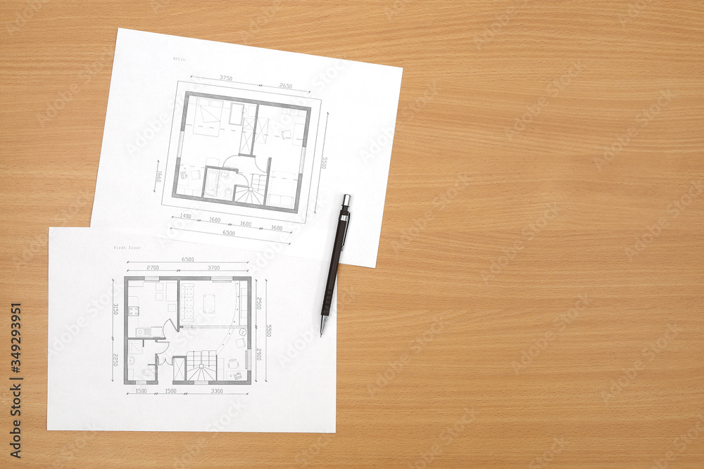 Architecture floor plan on paper is located on a table with a wood ...