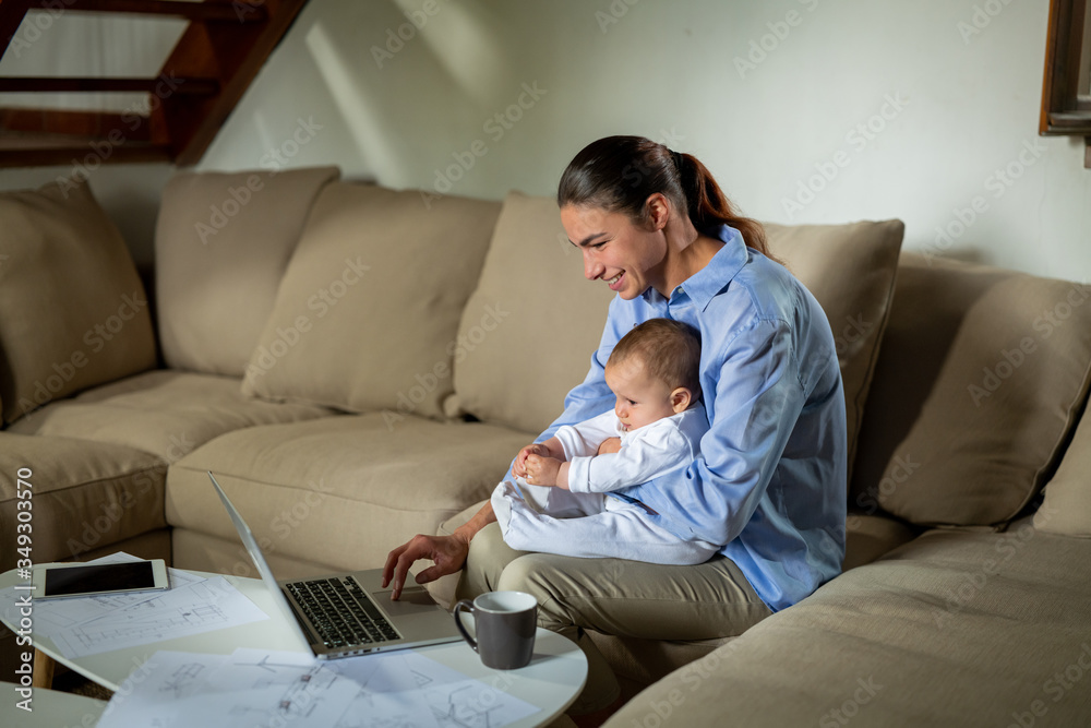 Authentic close up shot of young neo mother is doing smart working with ...