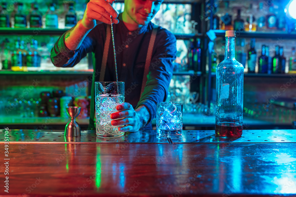 Professional barman finishes preparation of alcoholic cocktail for ...
