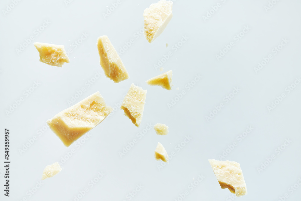 Parmesan cheese explodes and splits in different directions with crumbs ...
