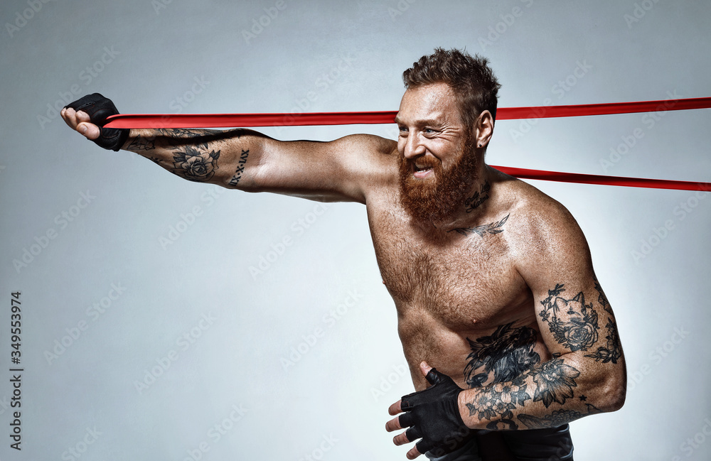 Strong man using resistance band in his exercise routine. Photo of man ...