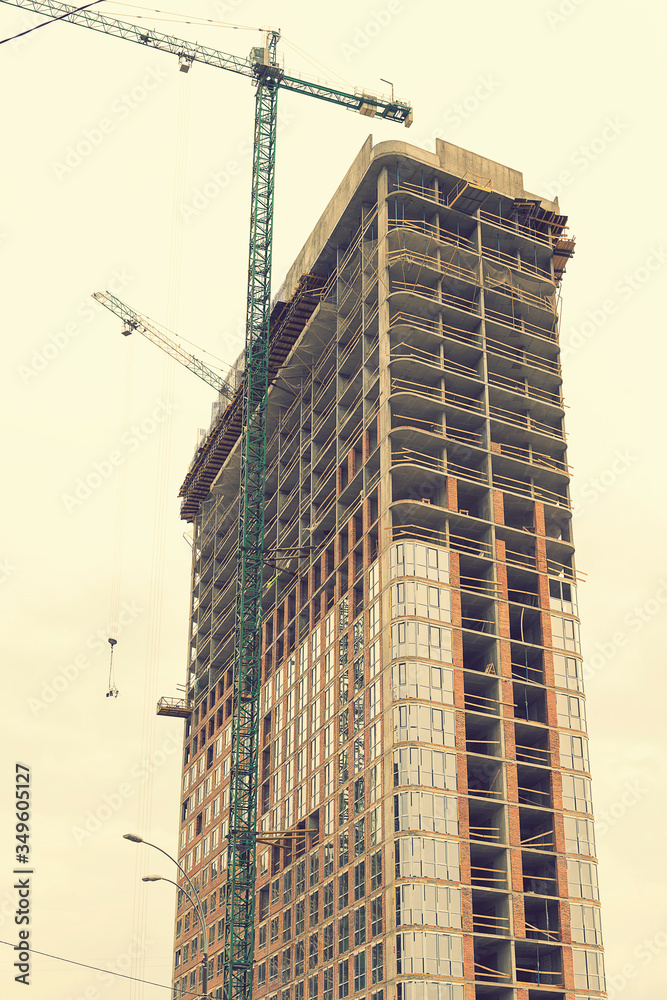 The stopped construction of a high-rise building. Unfinished floors of ...