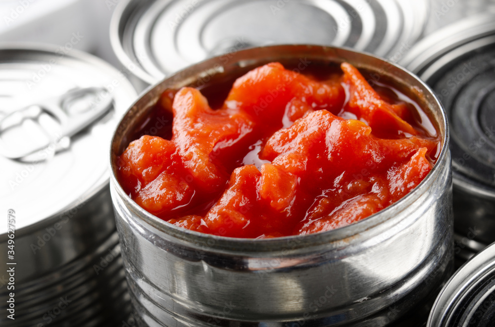 Canned sliced tomatoes in just opened tin can. Non-perishable food ...