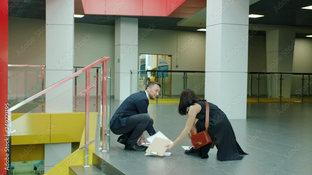 Man and woman colleagues are bumping into each other in office hall ...