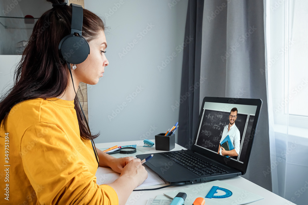 Beautiful girl using laptop studying at home, online education concept ...