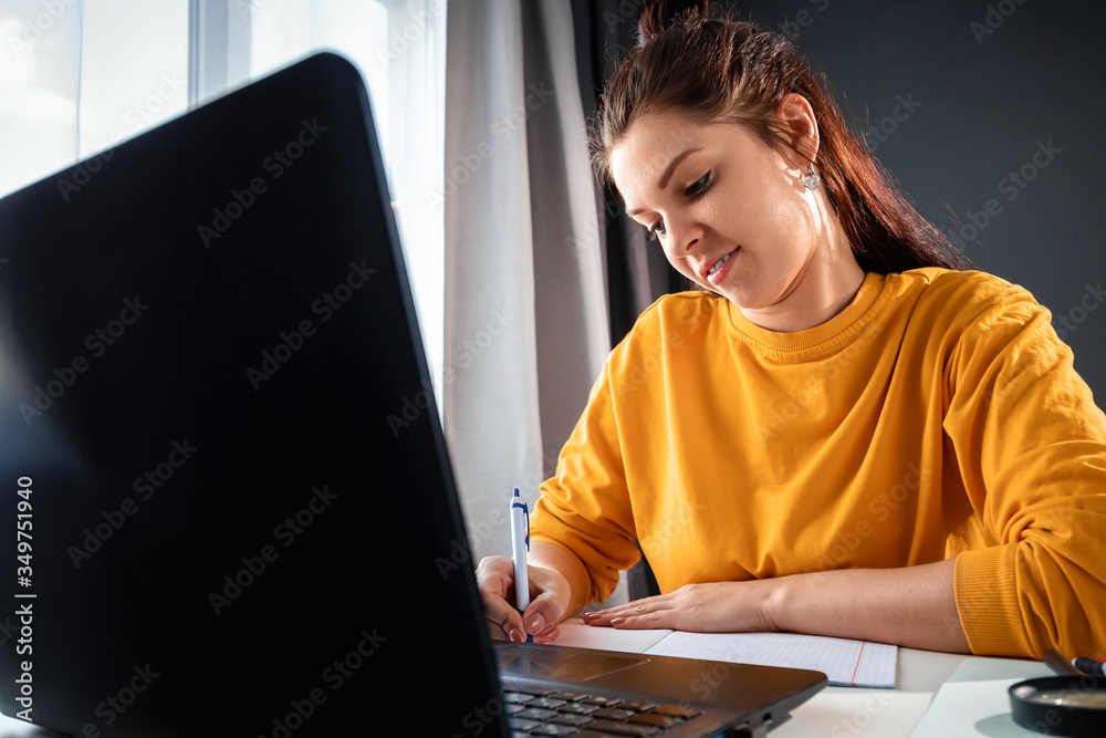 Beautiful girl using laptop studying at home, online education concept ...