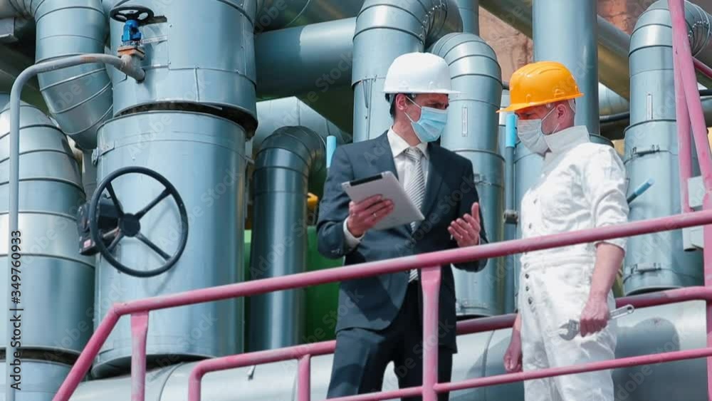 Communication of two masked workers in the technical part of the ...