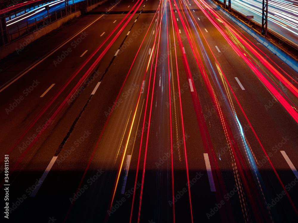 Light trails of the cars on a motorway at night. Seeing motion blurred ...