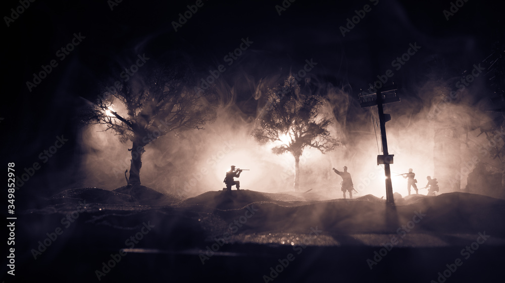 Army sniper with large caliber rifle standing in the fire and smoke ...