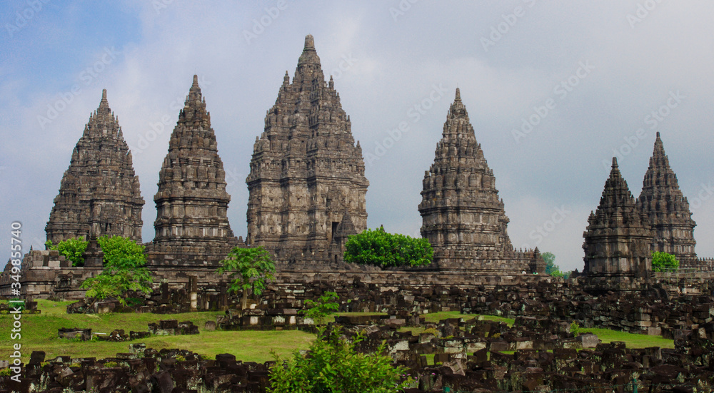 Ancient stone ruins on green field and Candi Prambanan or Rara ...