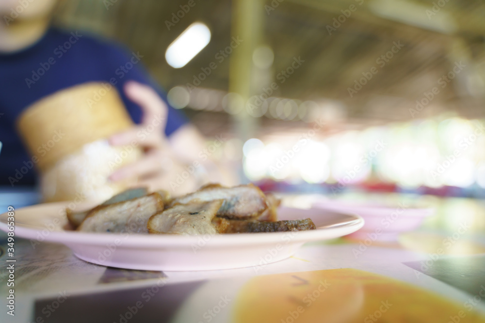 Eating grilled pork or cow udder meat Stock Photo | Adobe Stock