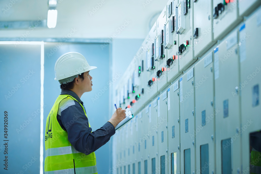 electrician working in a power station Stock Photo | Adobe Stock