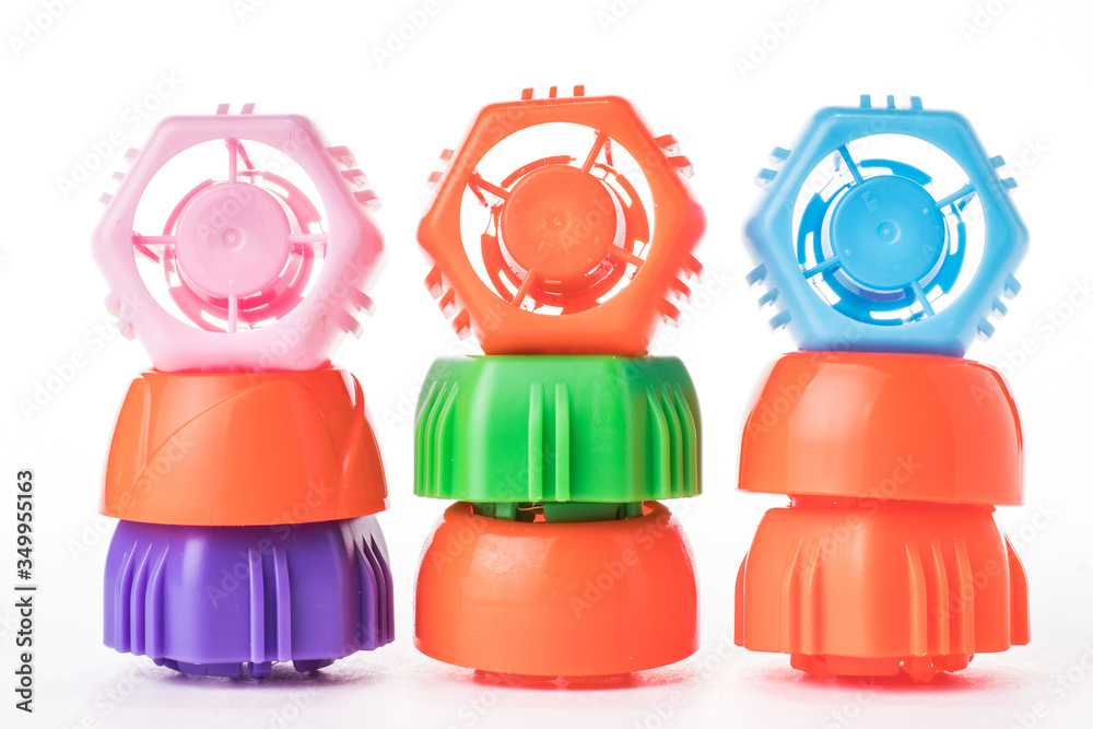 Three stacks of colored plastic bottle caps look like little men. Stock ...