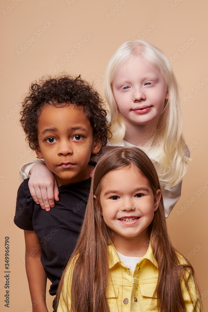 adorable kids of diverse nationalities and skin colors stand together ...