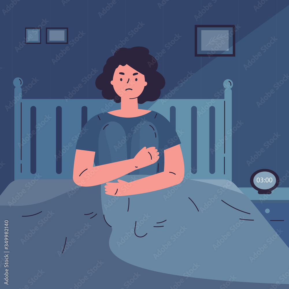 Depressed woman suffering from insomnia at night in her bedroom.A young ...