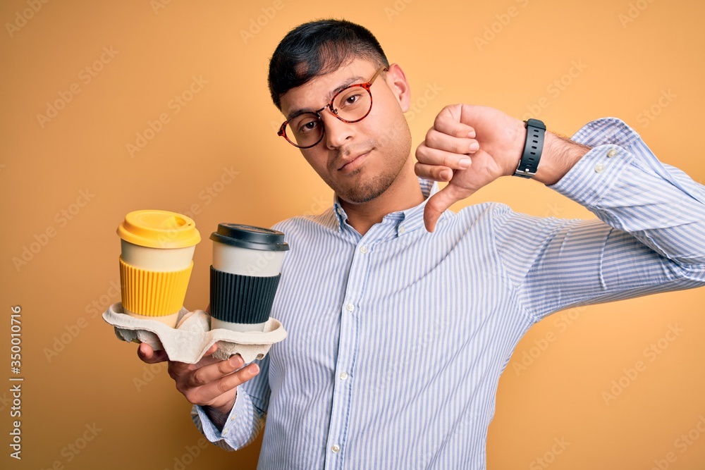 Young scholarship holder business man holding take away coffee over ...