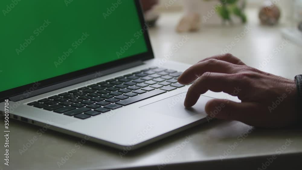computer laptop green screen working with close-up man, using finger ...