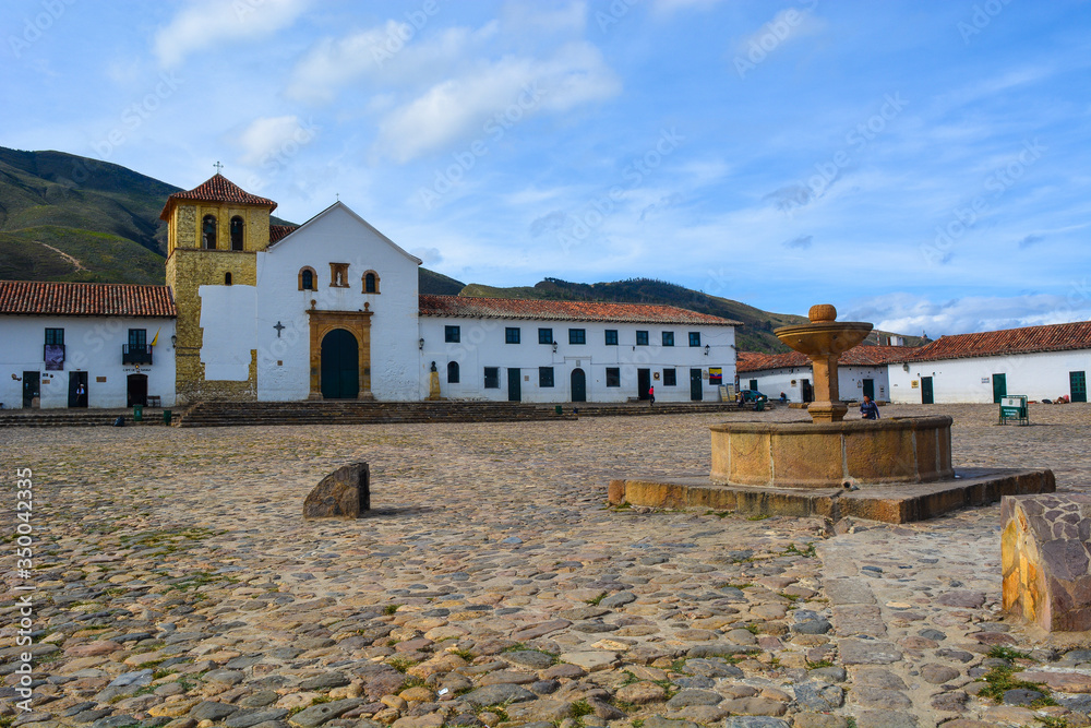 "Plaza Mayor" of Villa de Leyva, Boyacá with blue sky and cobbled paths ...
