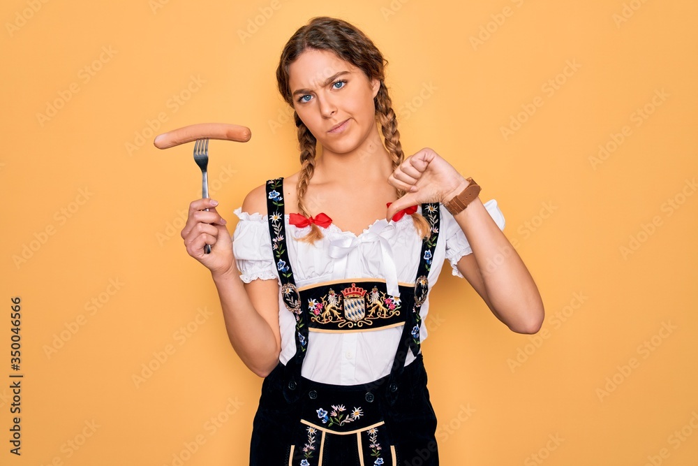 Beautiful german woman with blue eyes wearing oktoberfest dress holding ...
