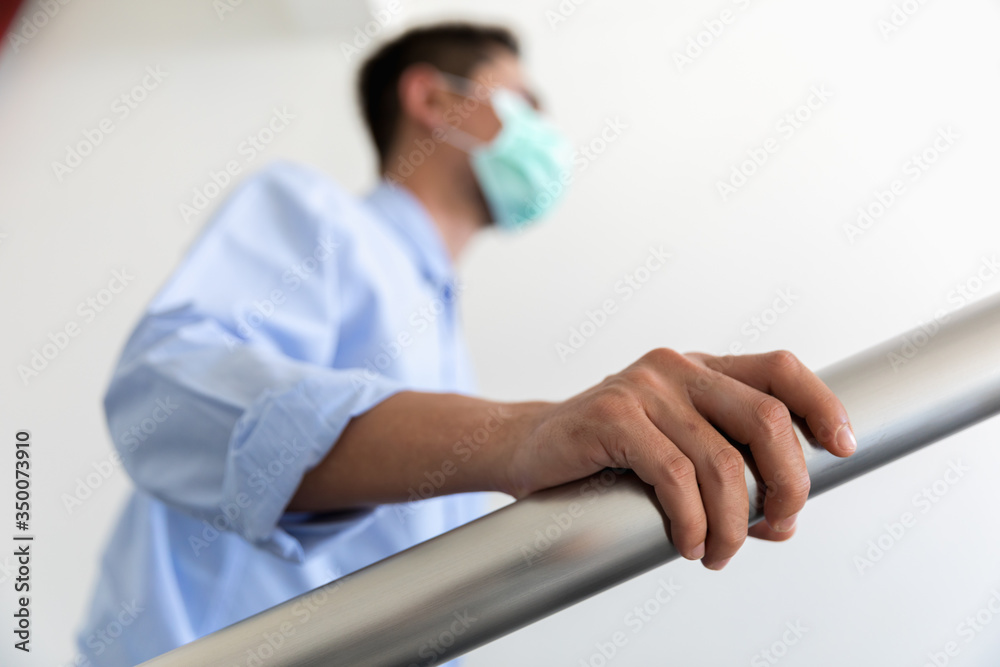 Hand holding banisters, The germ spread from person to person through ...
