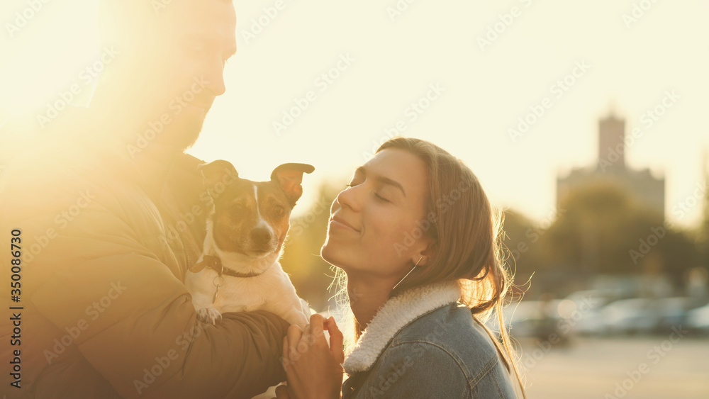 Romantic happy couple in love enjoying their time with pets. Loving ...