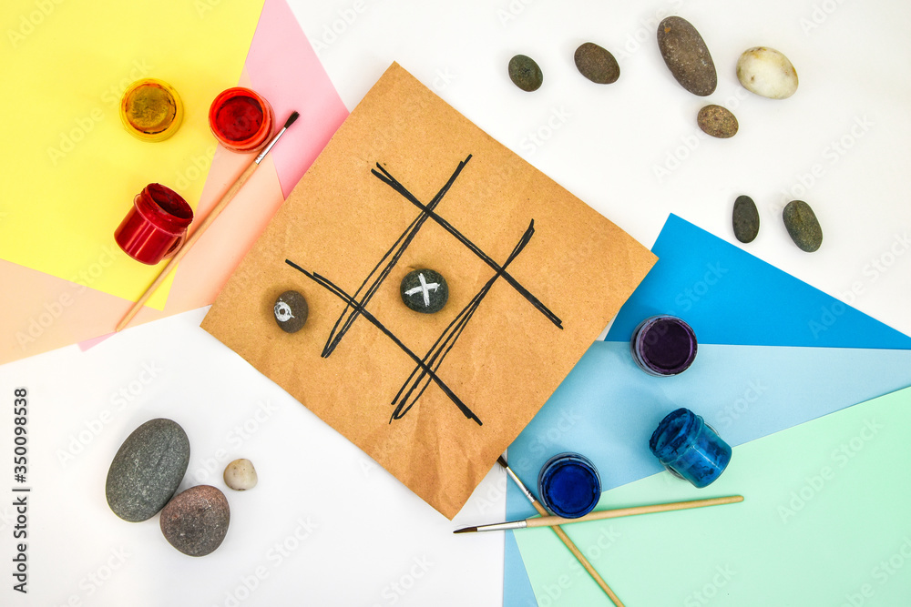 top view of tic tac toe game with stones marked with naughts and ...