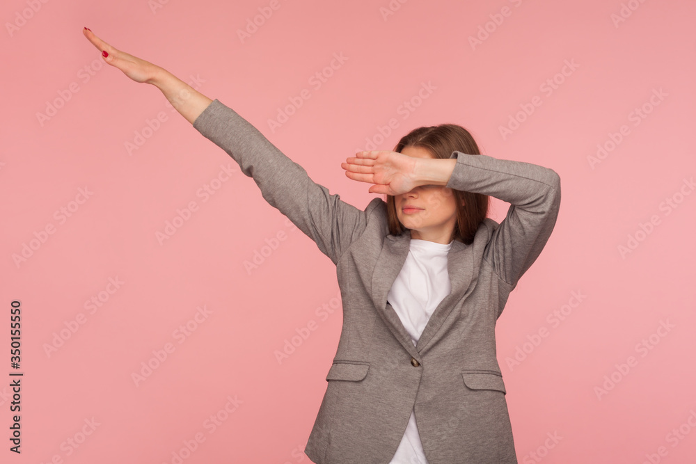 Portrait of successful young woman in business suit showing dab dance ...