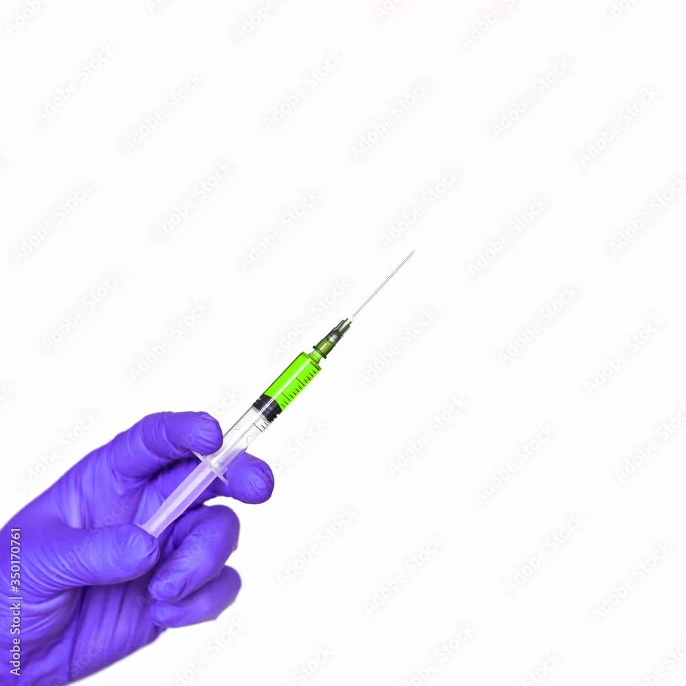 Doctor hand hold syringe in purple glove. Injection yellow vaccine ...